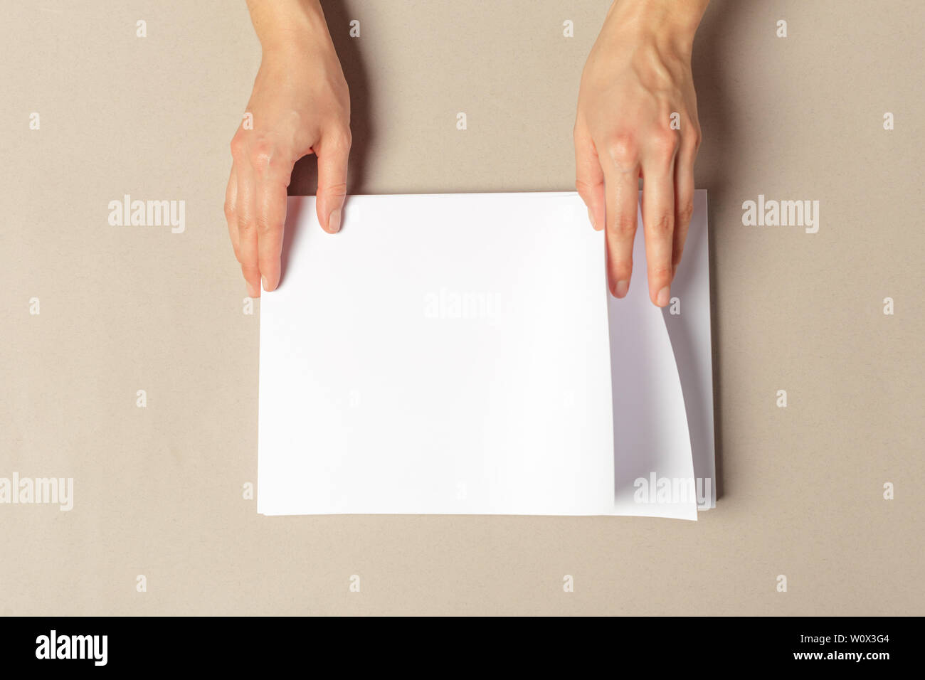 Hand holding papers a4 size Stock Photo - Alamy