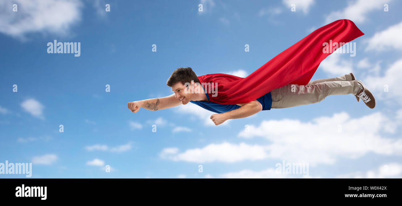 man in red superhero cape flying over sky Stock Photo - Alamy