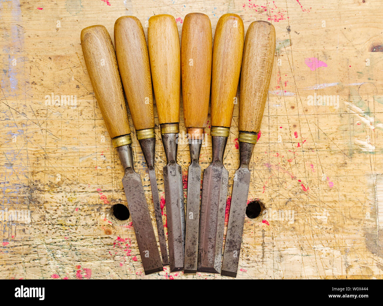 Group of assorted woodworking chisels isolated on wooden bench grunge ...