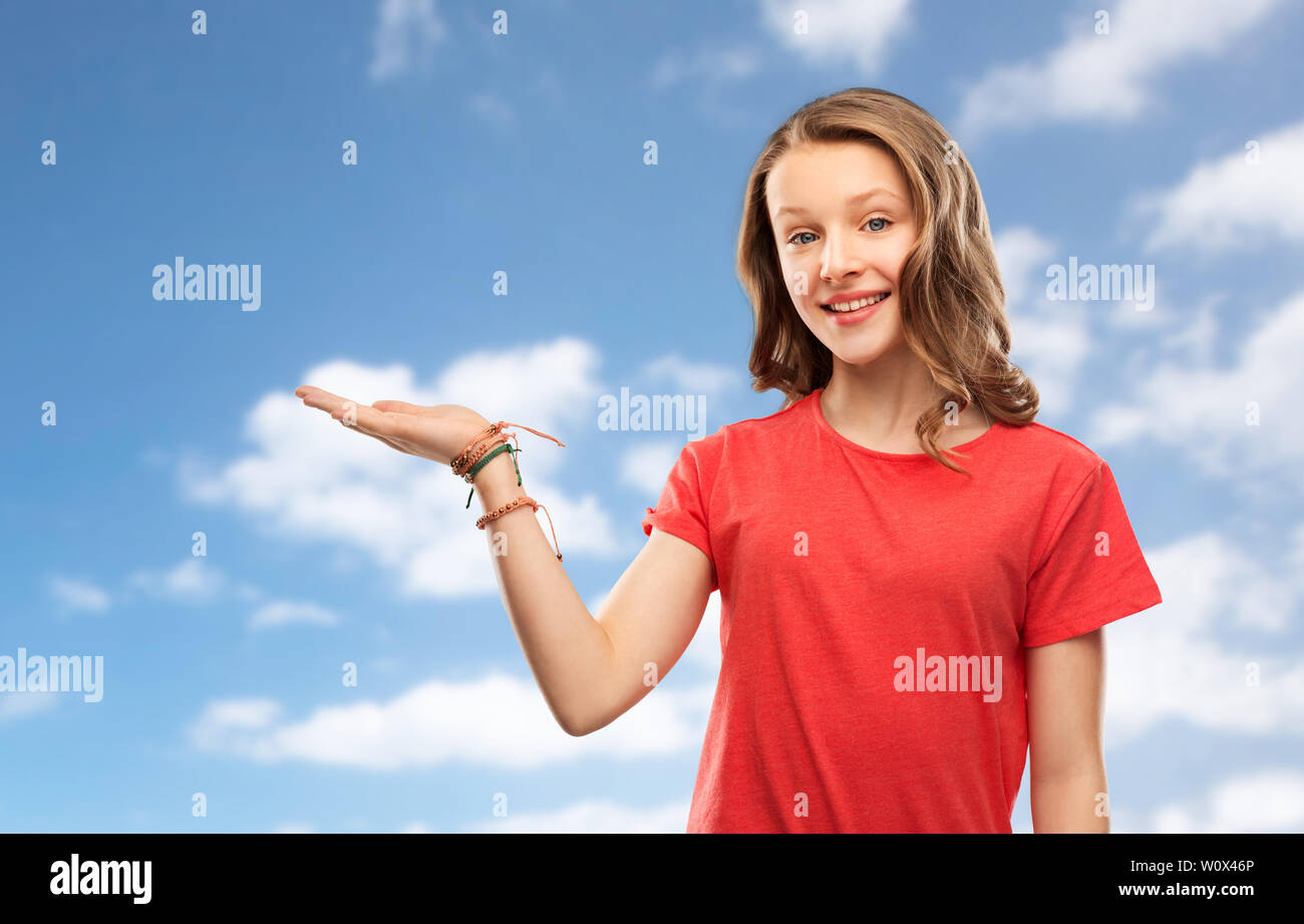 smiling teenage girl holding empty hand Stock Photo - Alamy