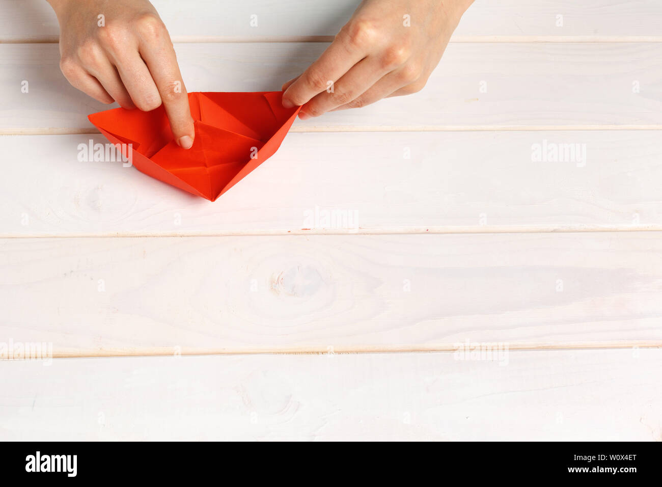 Process of handcrafting origami paper boat Stock Photo - Alamy