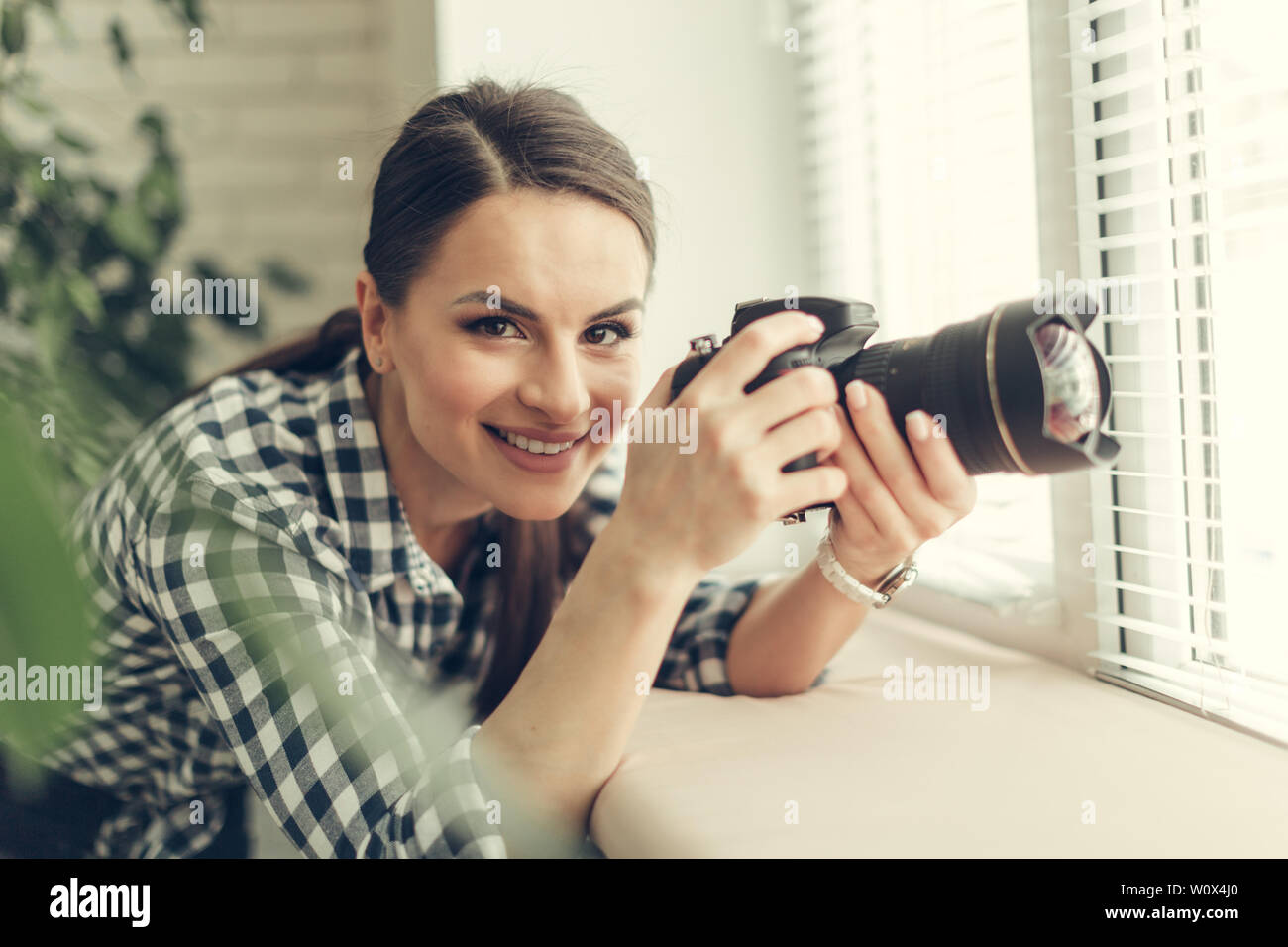 Pretty woman is a professional photographer with dslr camera Stock ...