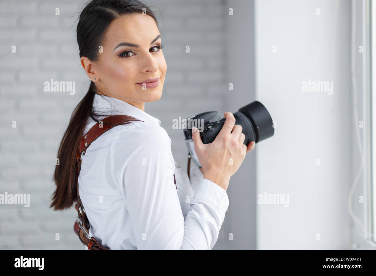 Pretty woman is a professional photographer with dslr camera Stock ...