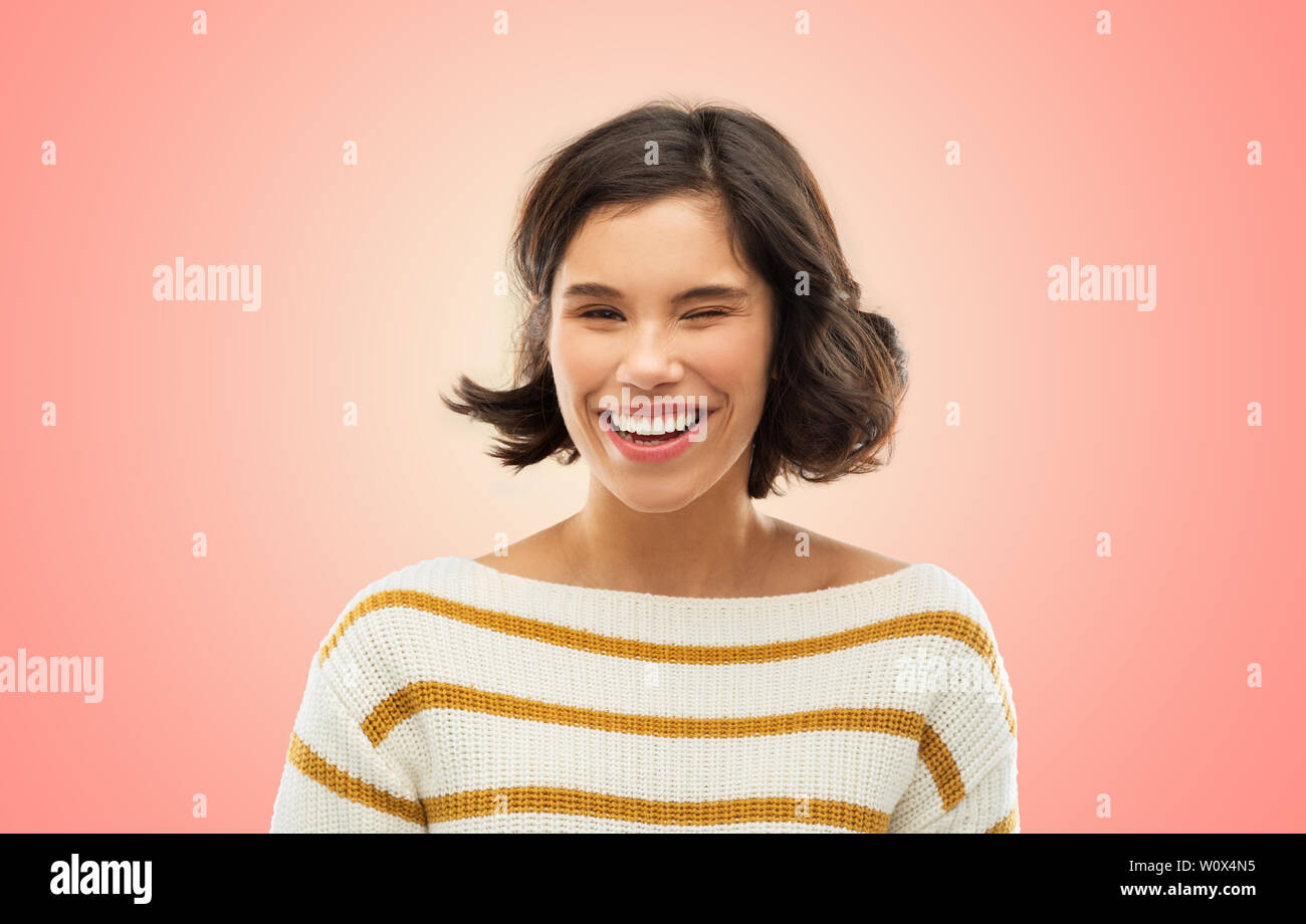 happy smiling woman in striped pullover winking Stock Photo - Alamy