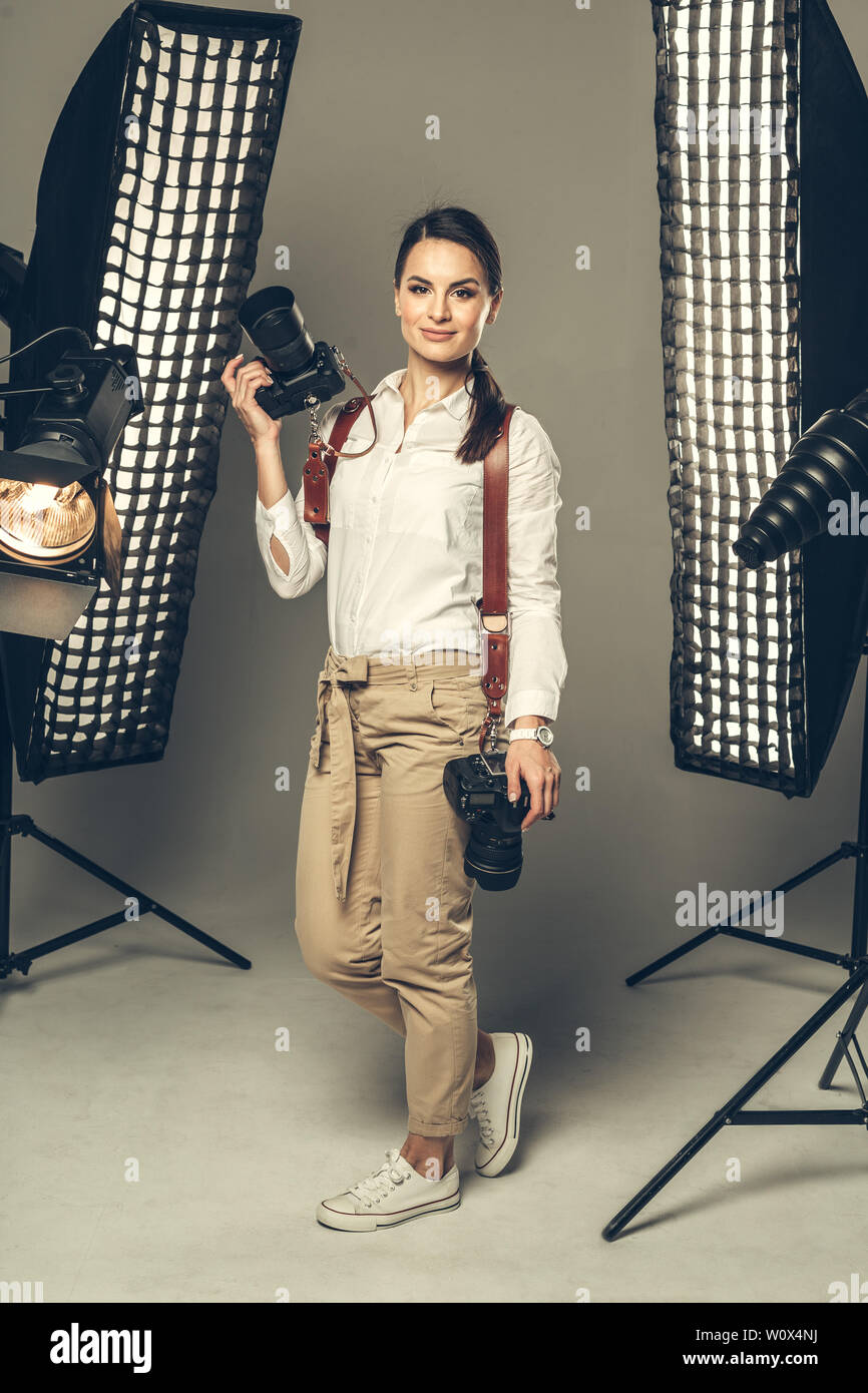 Pretty woman is a professional photographer with dslr camera Stock ...