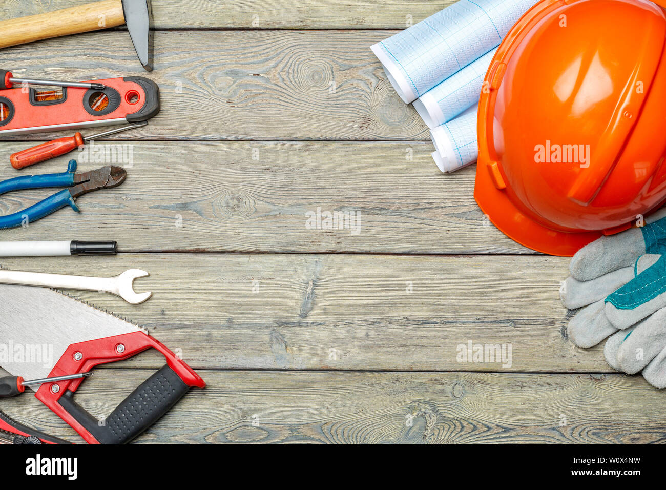 Assorted work tools on wooden table Stock Photo - Alamy