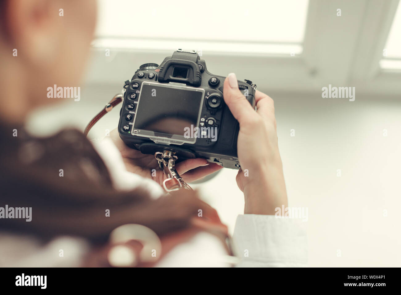 Pretty woman is a professional photographer with dslr camera Stock ...