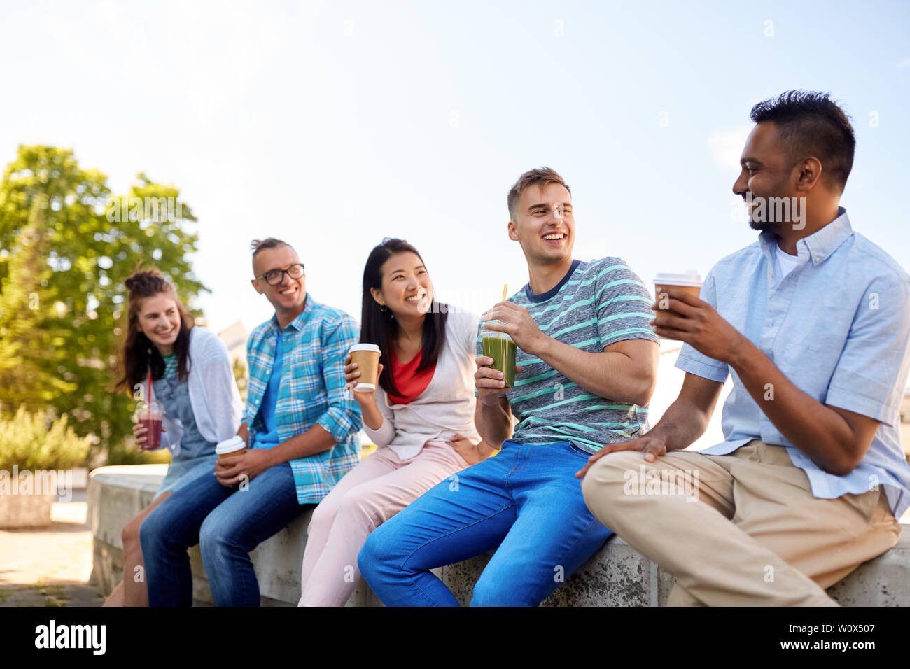 Friends drinking coffee juice talking hi-res stock photography and ...