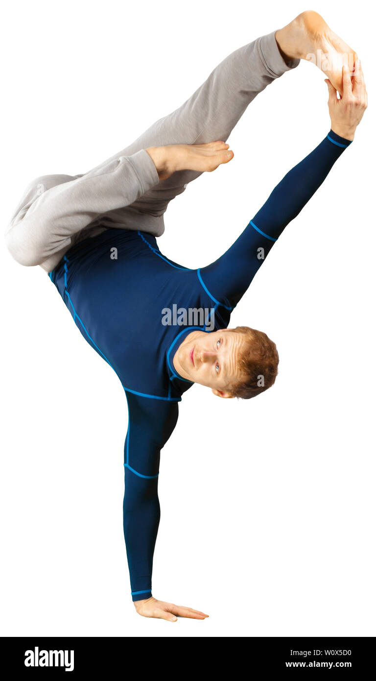 Flexible sporty young man doing stretching exercises isolated on white ...