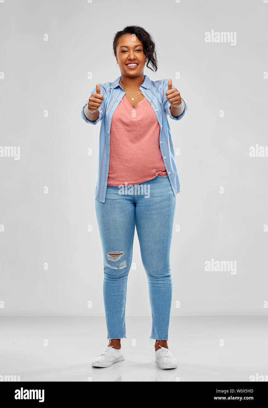 happy african american woman showing thumbs up Stock Photo - Alamy