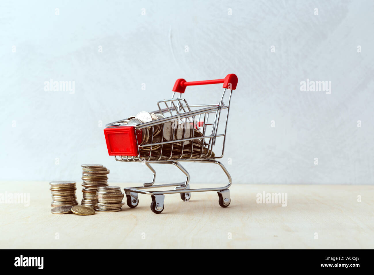 Saving Money Concept. Shopping trolley or cart with coin Stock Photo ...