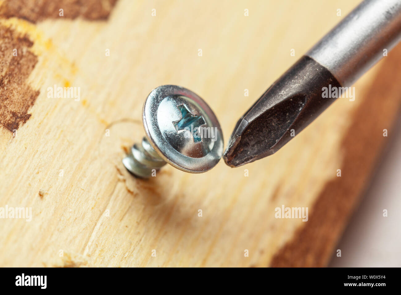 screw screwed into a wooden bar Stock Photo - Alamy