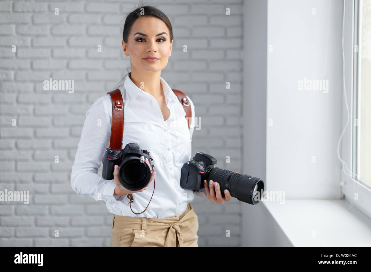 Pretty woman is a professional photographer with dslr camera Stock ...