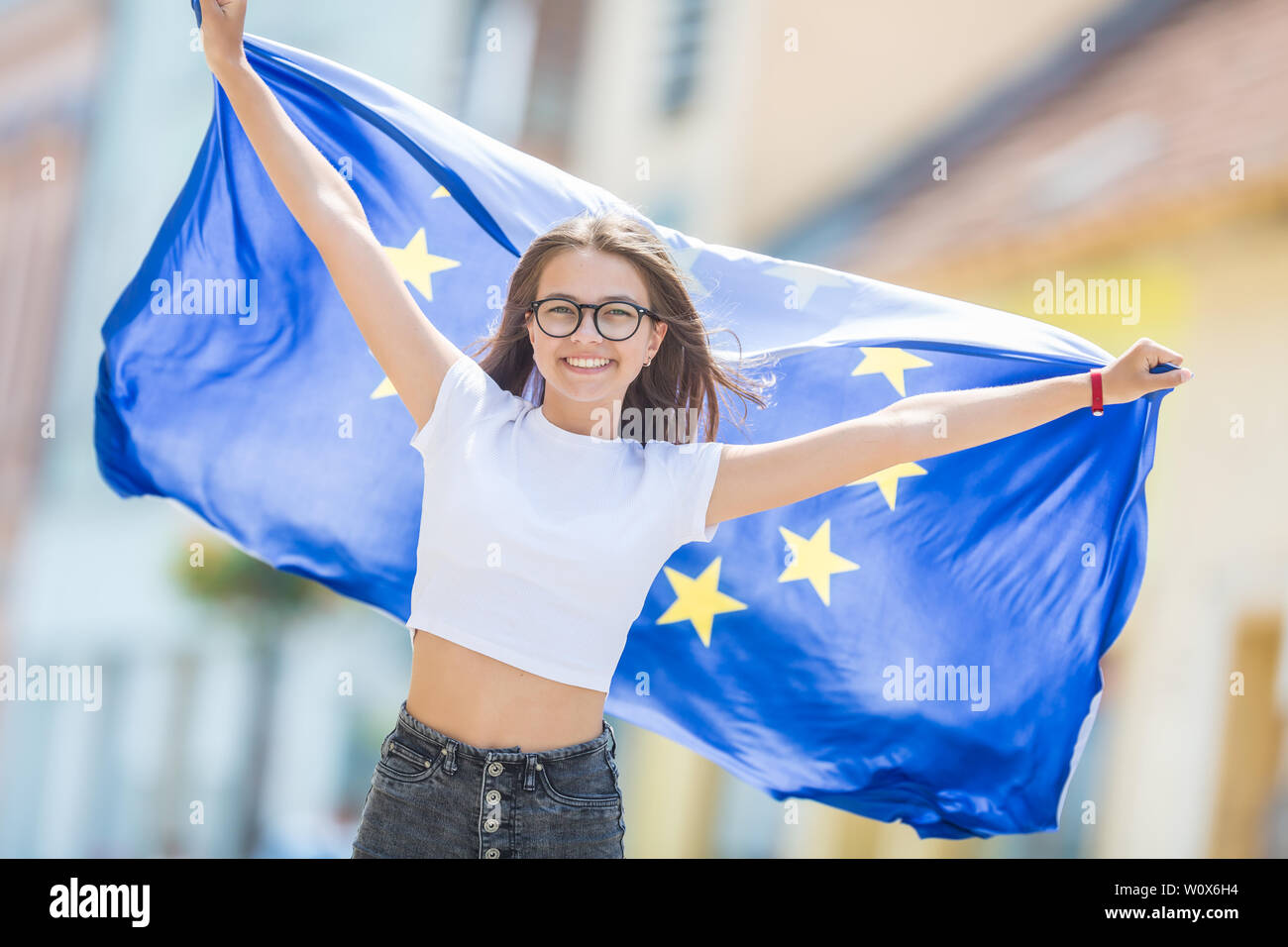 Cute happy young girl with the flag of the European Union in the ...