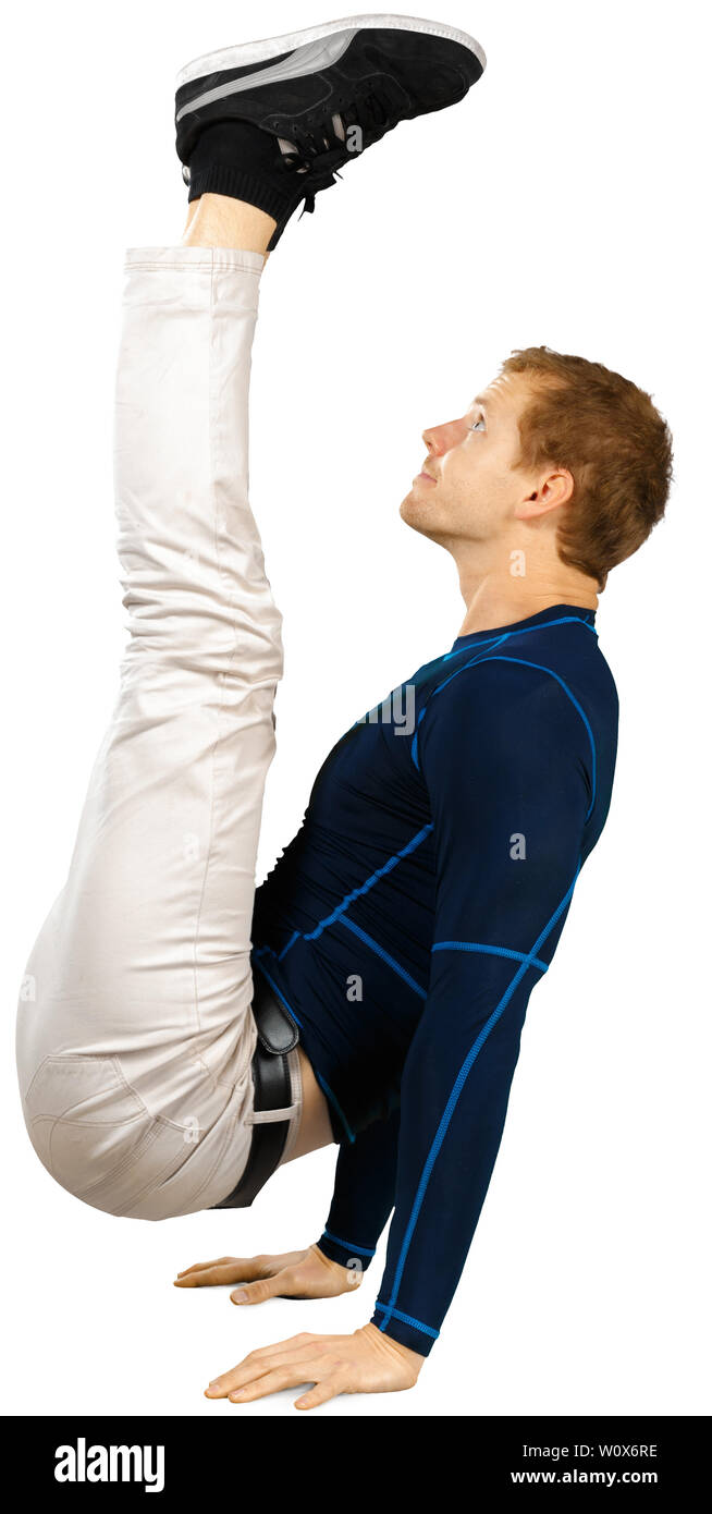 Flexible sporty young man doing stretching exercises isolated on white ...