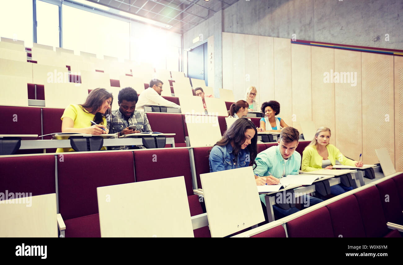 group of students with notebooks at lecture hall Stock Photo - Alamy