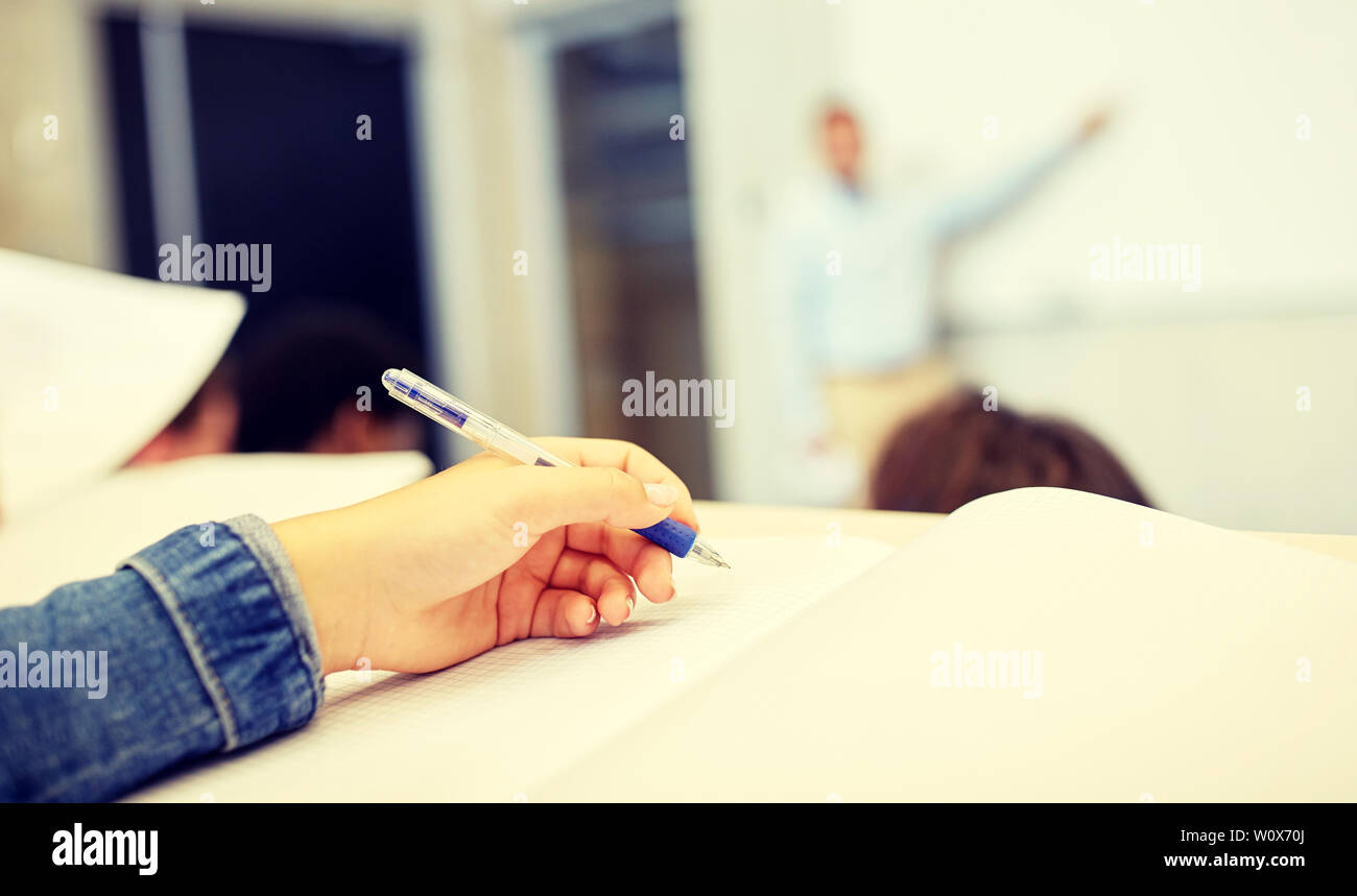 student hand writing to notebook at lecture Stock Photo - Alamy