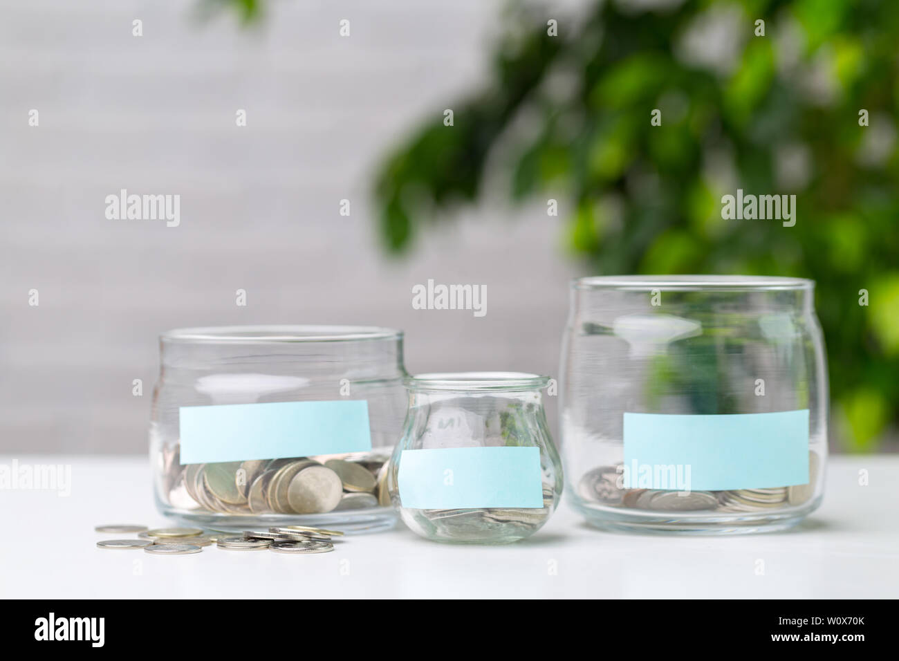 Glass jar with coins Stock Photo - Alamy