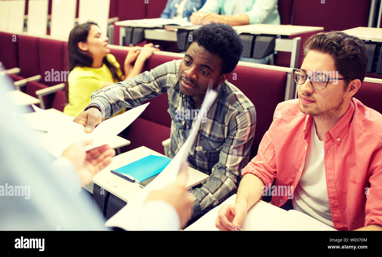 teacher giving tests to students at lecture Stock Photo - Alamy
