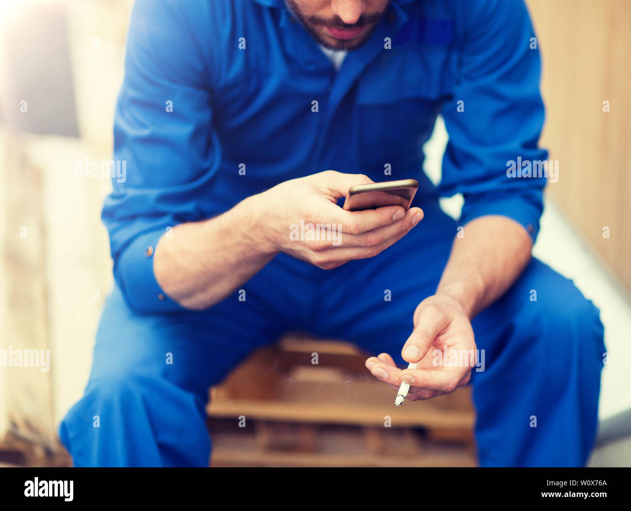 auto mechanic smoking cigarette at car workshop Stock Photo - Alamy