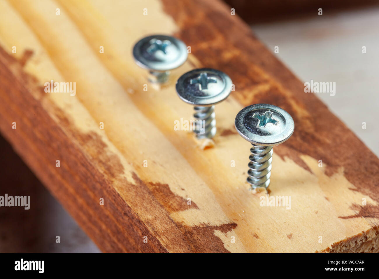 screw screwed into a wooden bar Stock Photo - Alamy