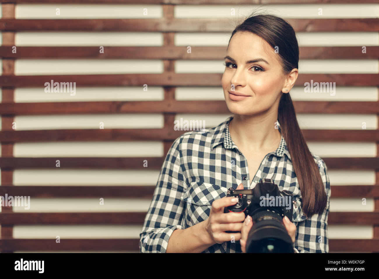 Pretty woman is a professional photographer with dslr camera Stock ...