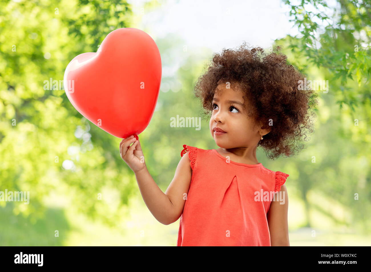 african american girl with heart shaped balloon Stock Photo - Alamy