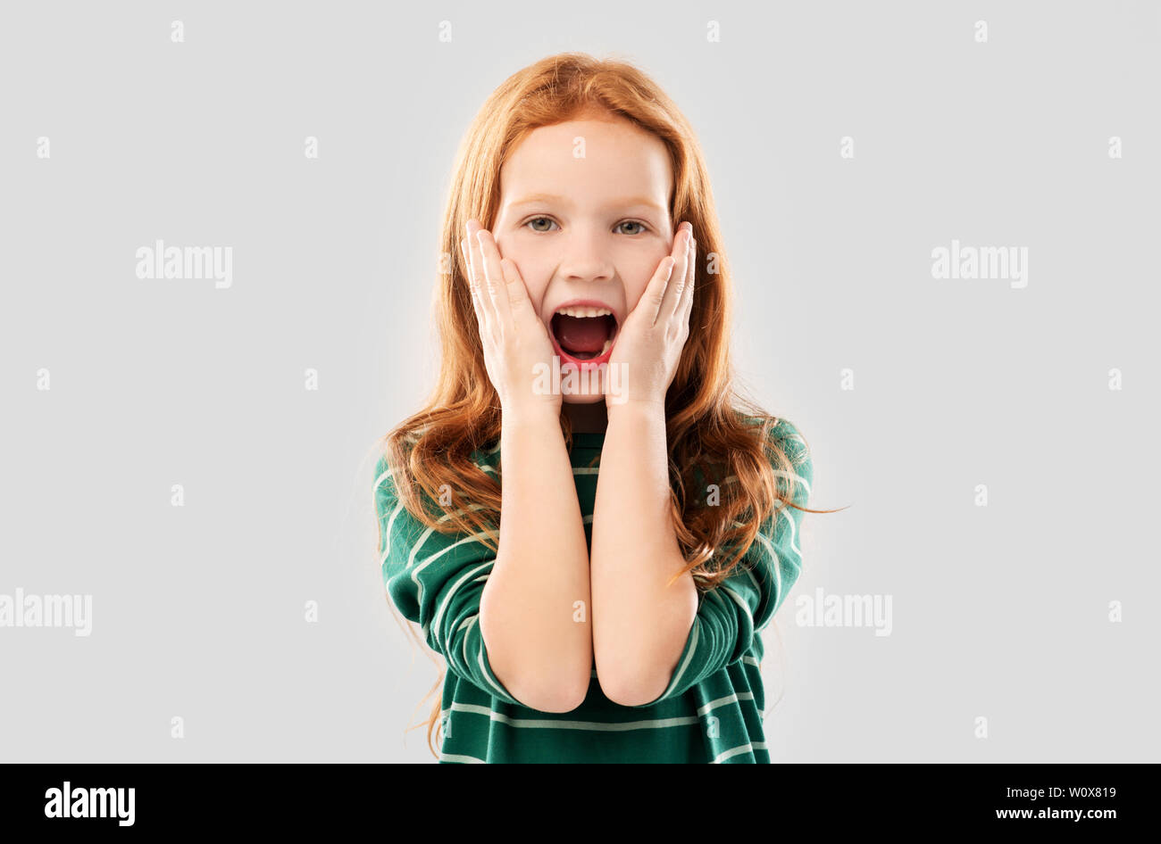 shocked or surprised red haired girl screaming Stock Photo - Alamy