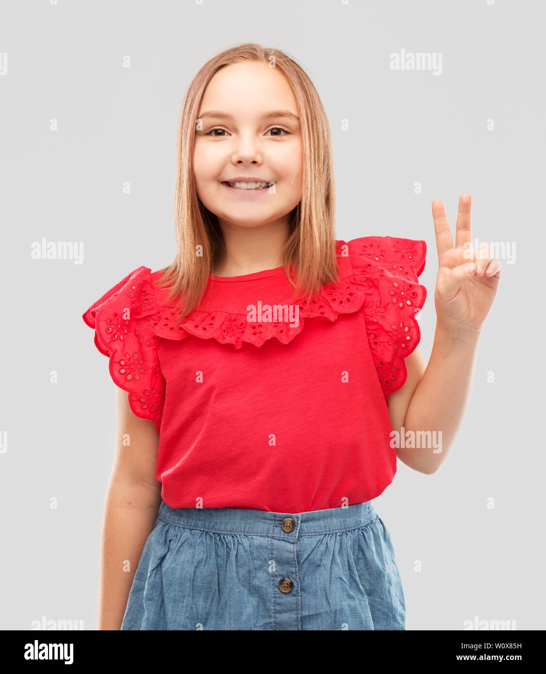 beautiful smiling girl showing peace sign Stock Photo - Alamy