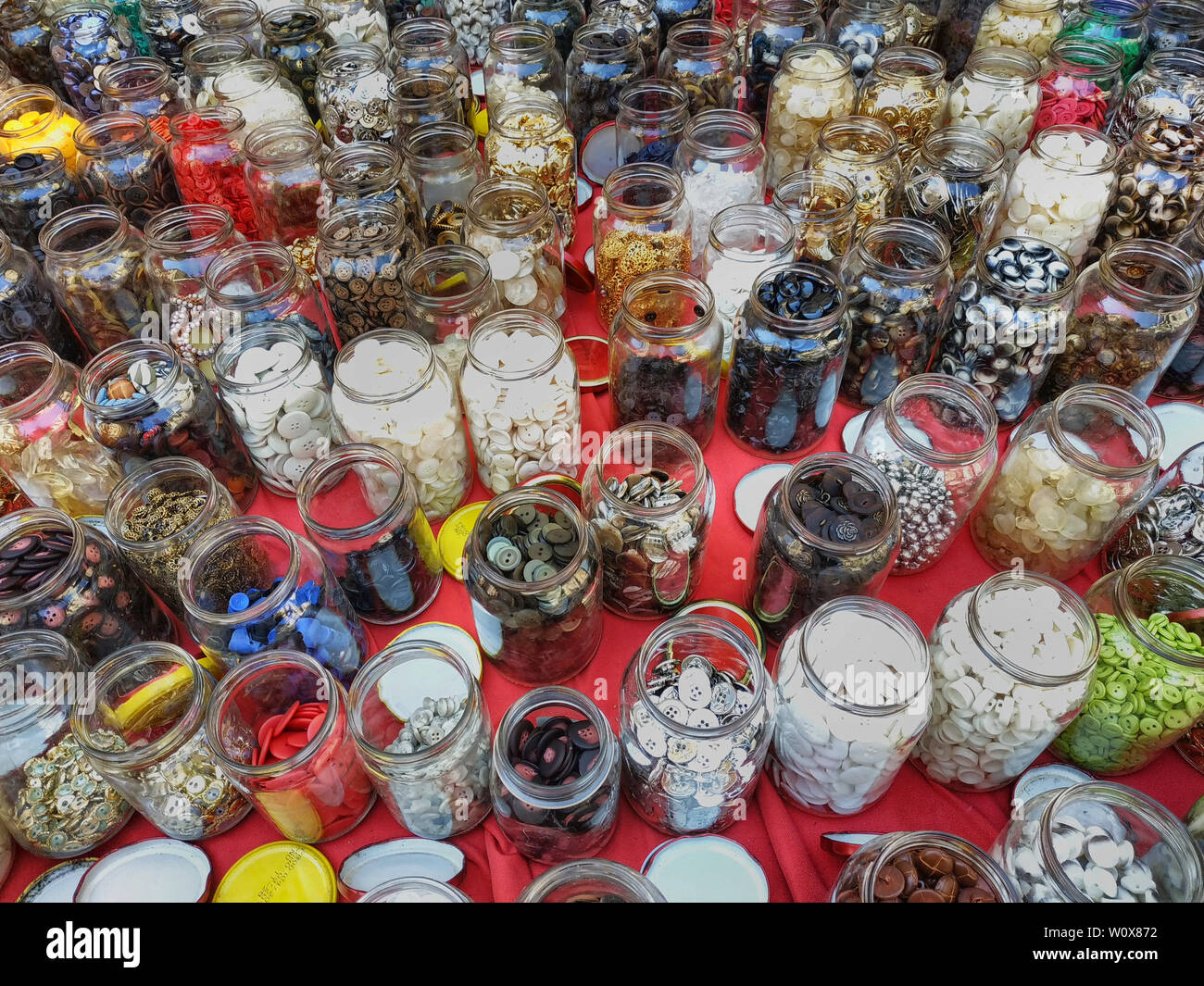 In a market stall filled with glass jars full of buttons of every shape ...