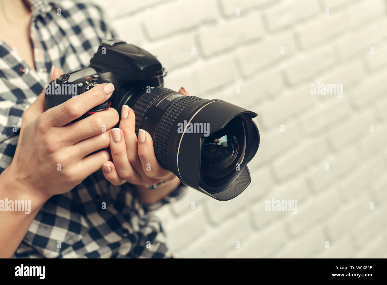 Pretty woman is a professional photographer with dslr camera Stock ...