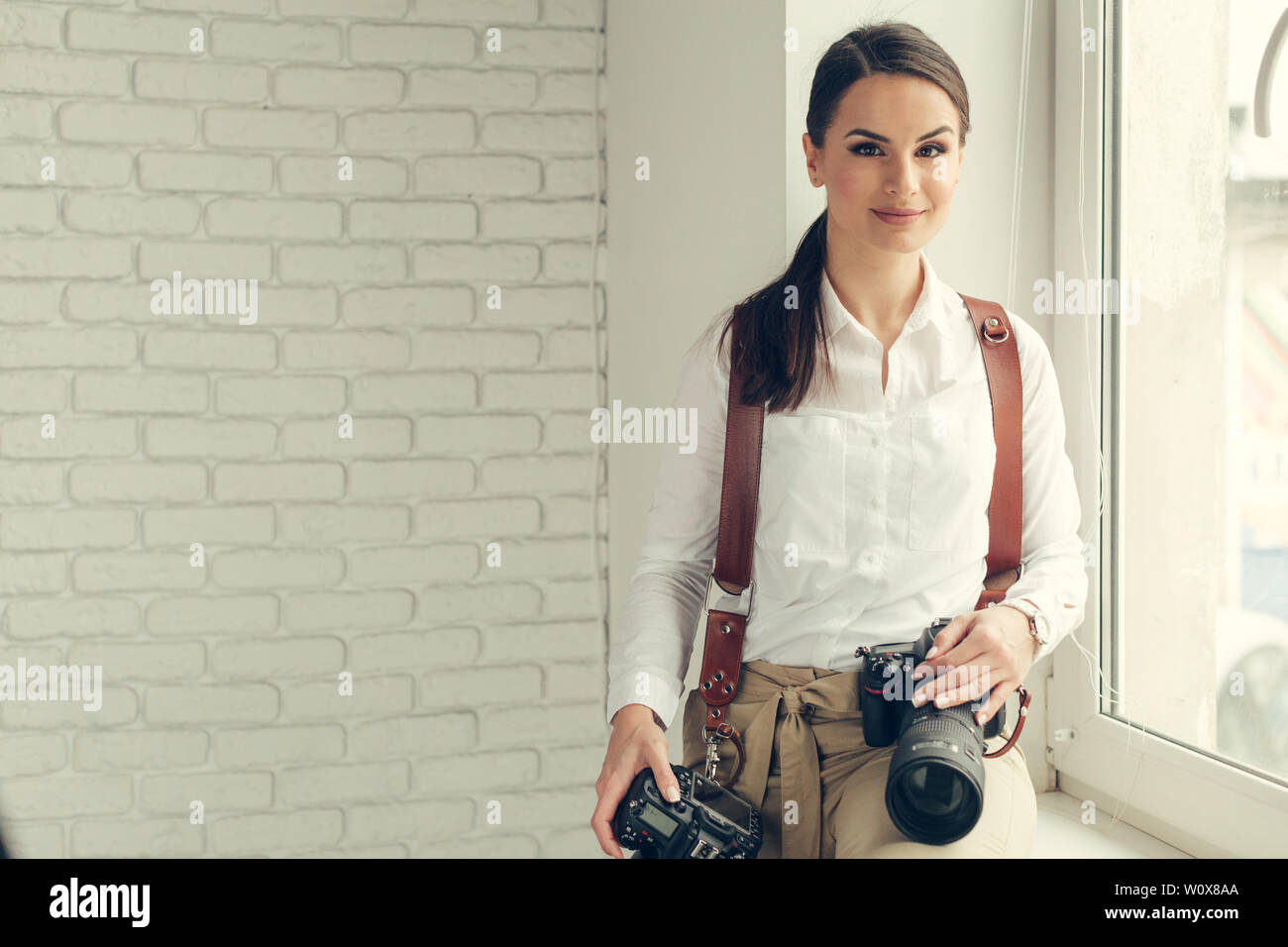 Pretty woman is a professional photographer with dslr camera Stock ...