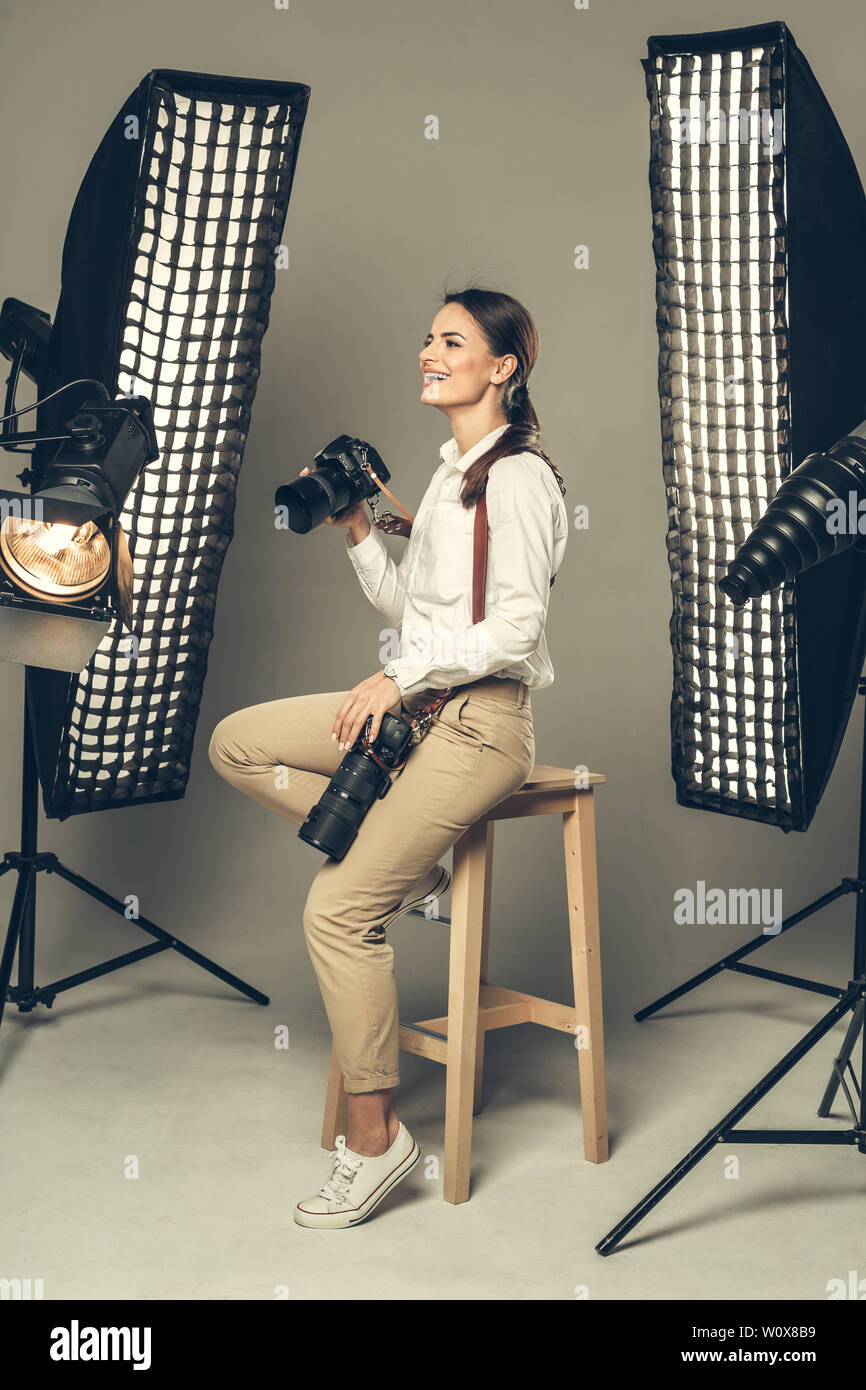 Pretty woman is a professional photographer with dslr camera Stock ...