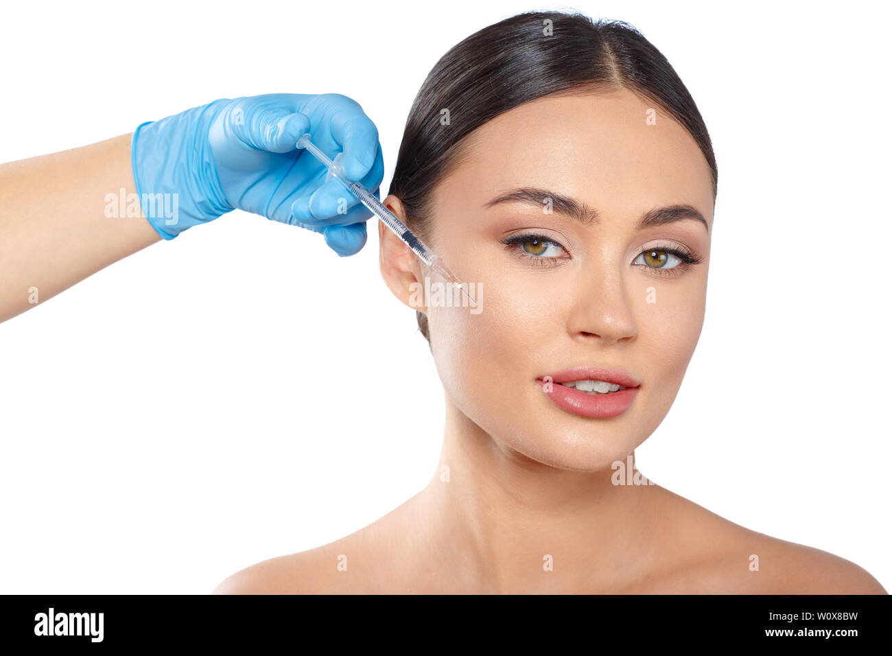 Portrait of an attractive young woman receiving botox treatment Stock ...