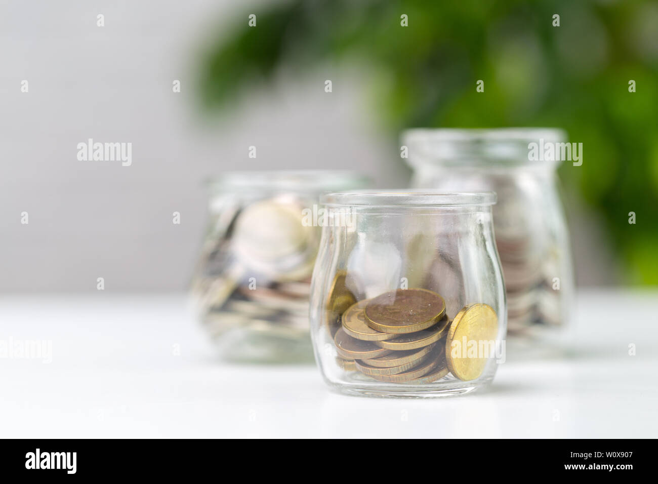 Coins in Glass Bottles Stock Photo - Alamy