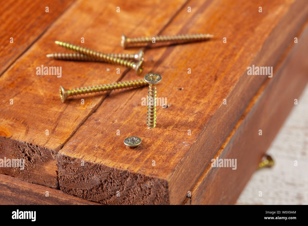 screws on a wooden table Stock Photo - Alamy