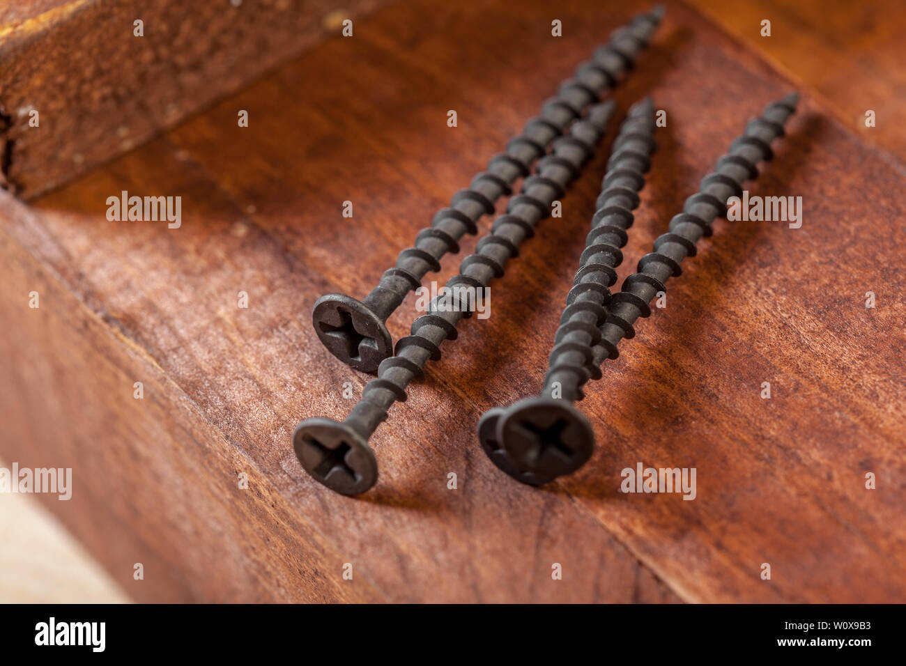 screws on a wooden table Stock Photo - Alamy
