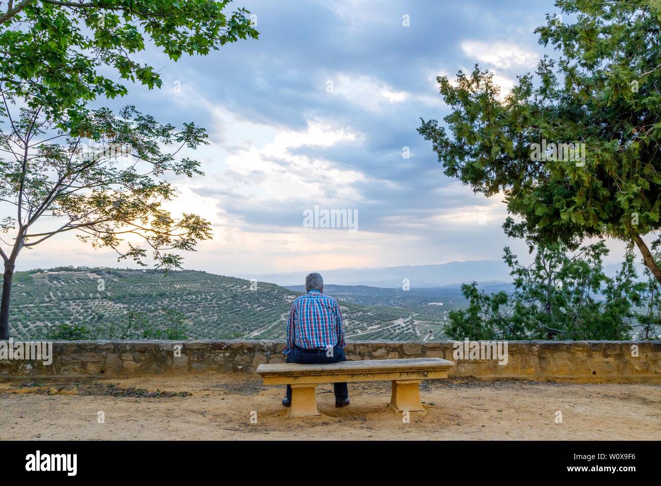 Man sitting on bench at sunset hi-res stock photography and images - Alamy
