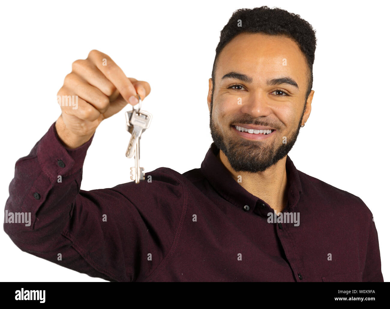 Happy positive black man realtor or owner of a new house holding his ...