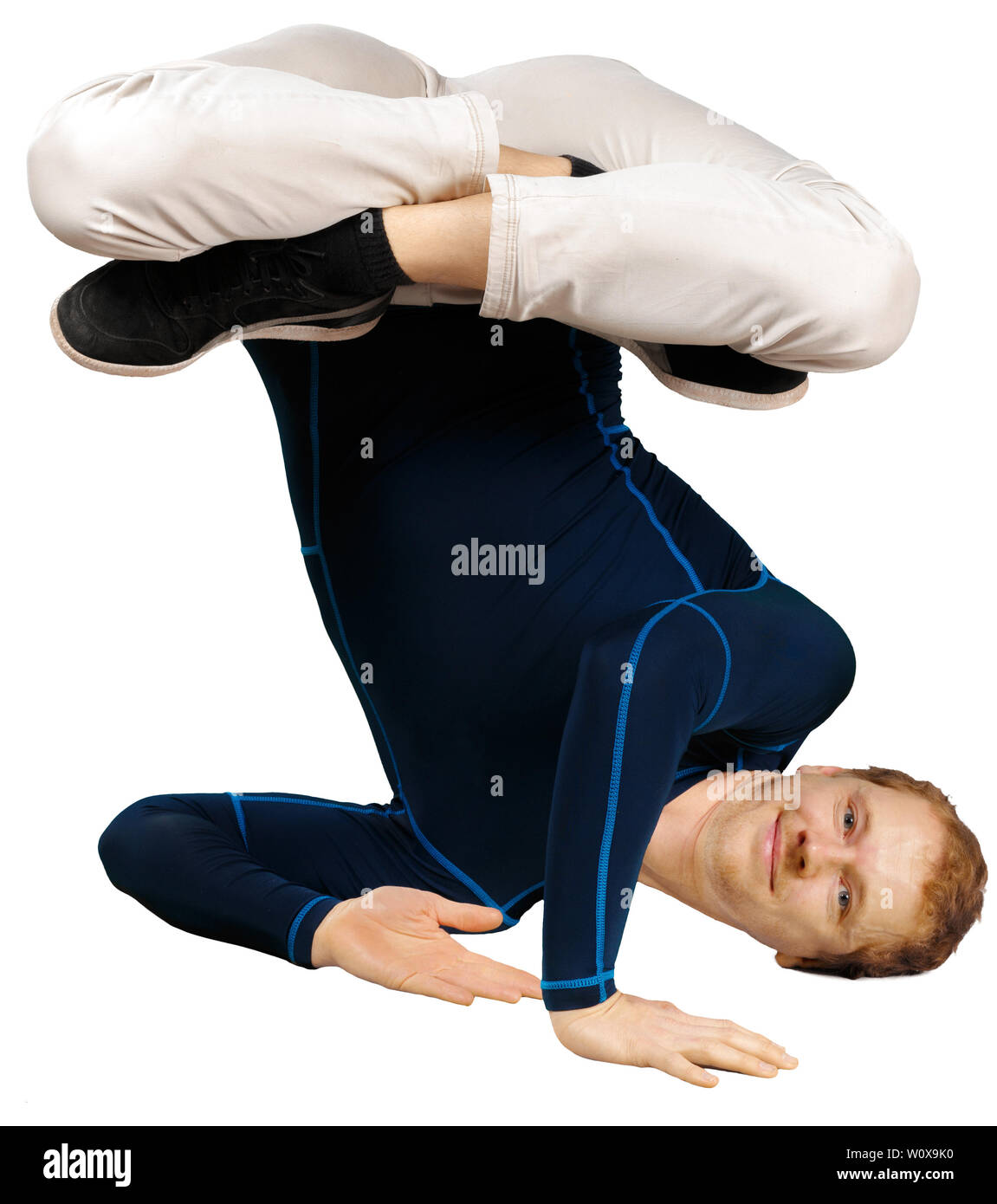 Flexible sporty young man doing stretching exercises isolated on white ...