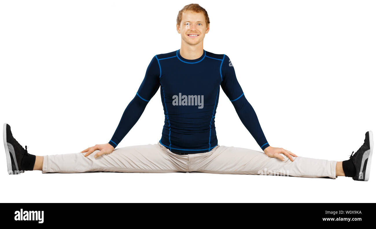 Flexible sporty young man doing stretching exercises isolated on white ...