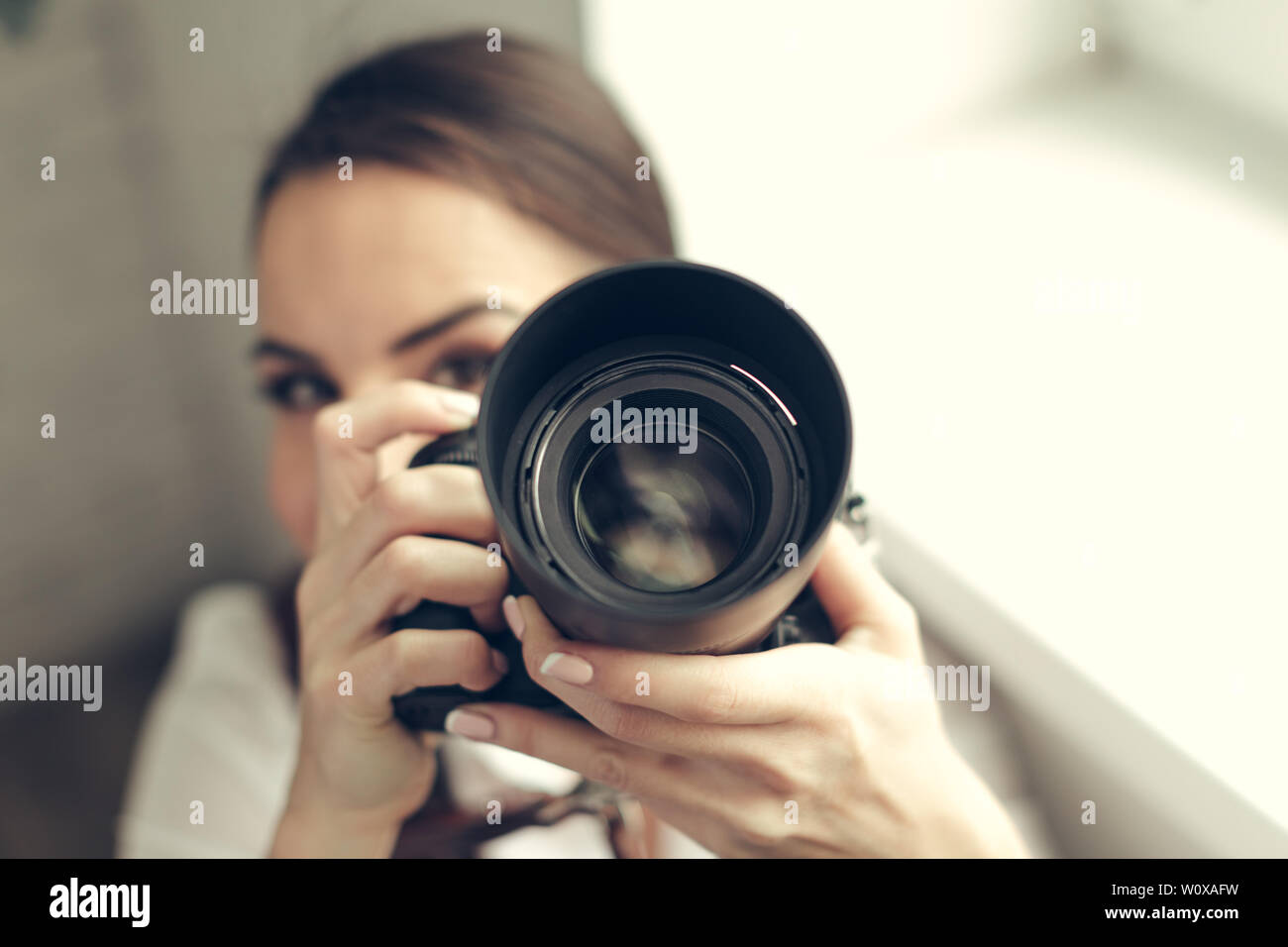 Pretty woman is a professional photographer with dslr camera Stock ...