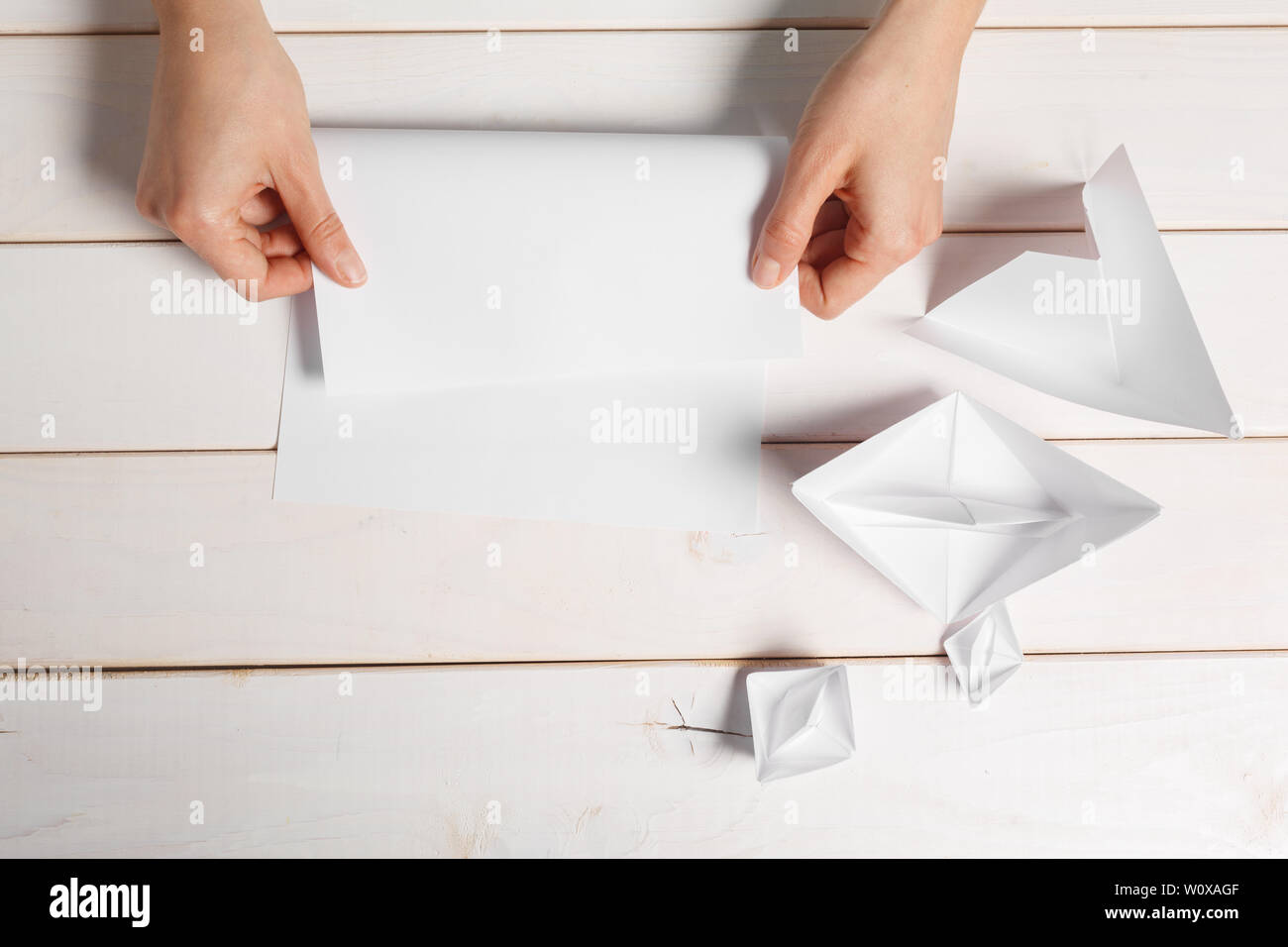 Process of handcrafting origami paper boat Stock Photo - Alamy