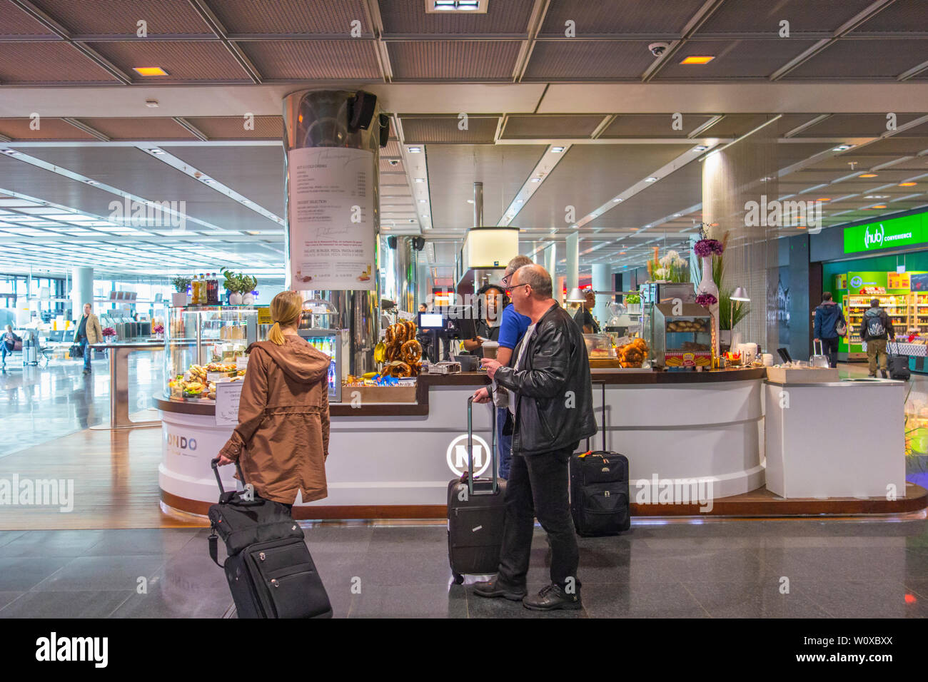 Flight passengers at a terminal in an airport Stock Photo - Alamy