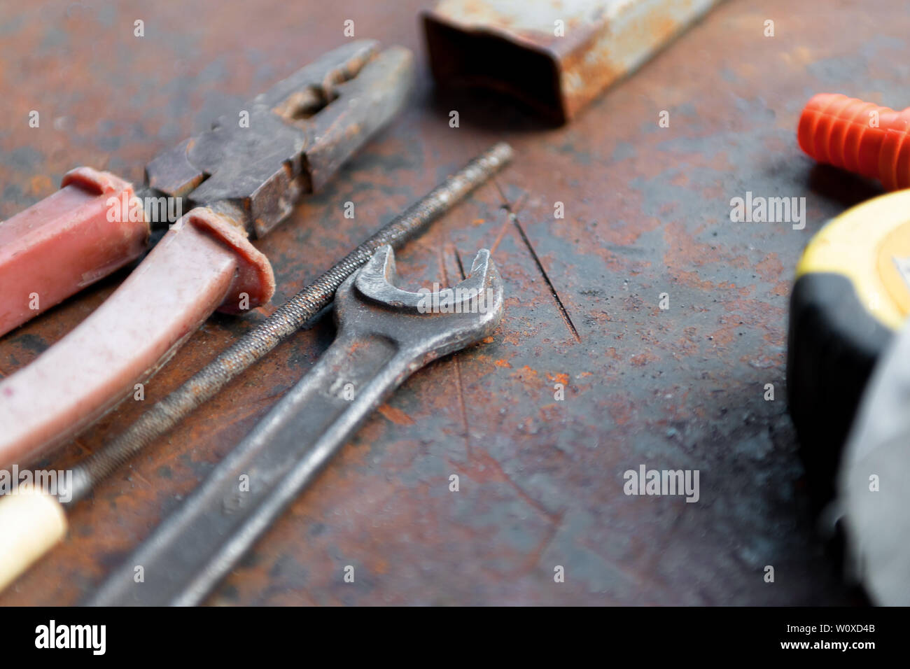 Working tools on a dirty rough workbench Stock Photo - Alamy