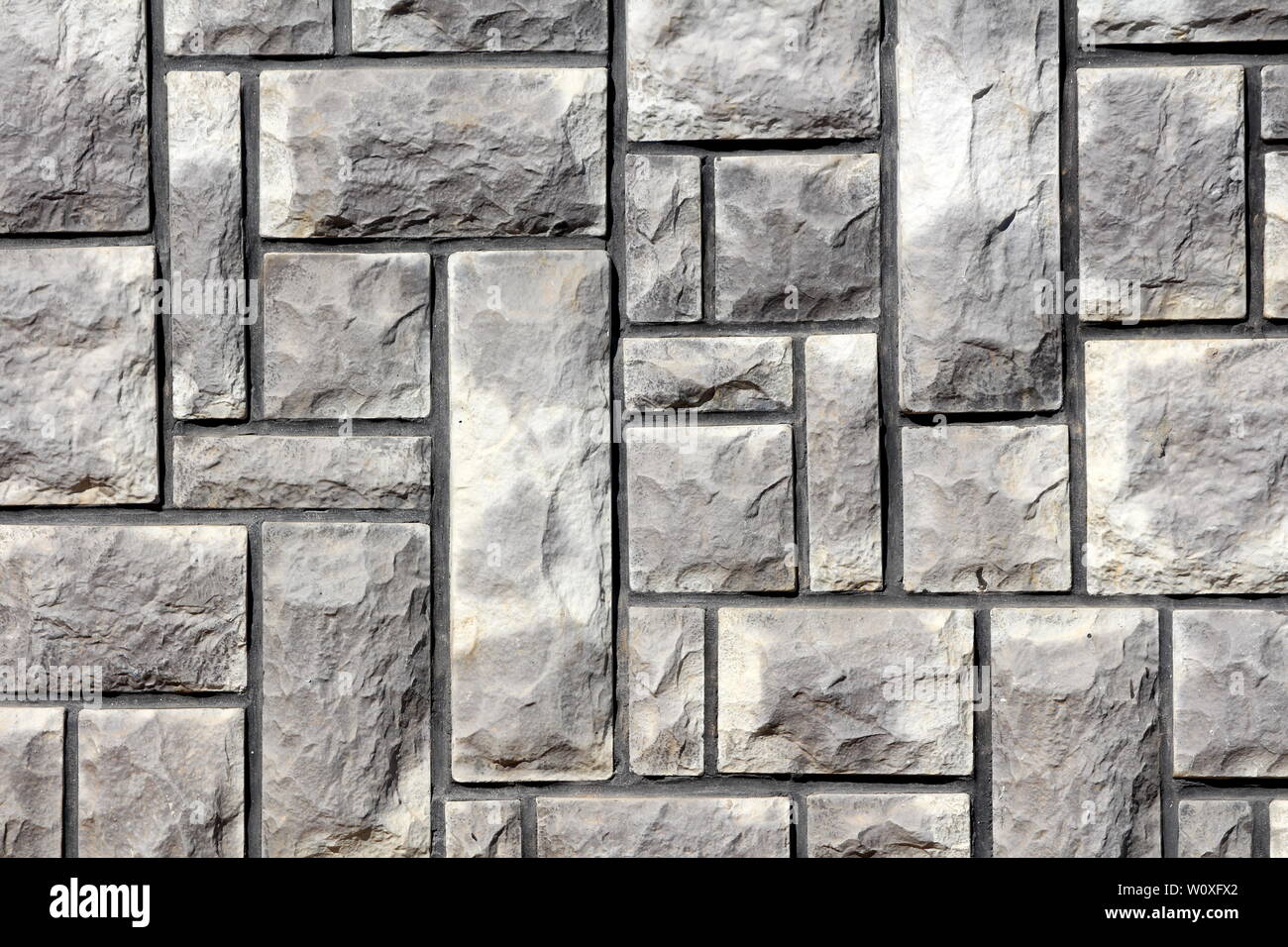 Natural light stone tiles on family house wall texture background ...