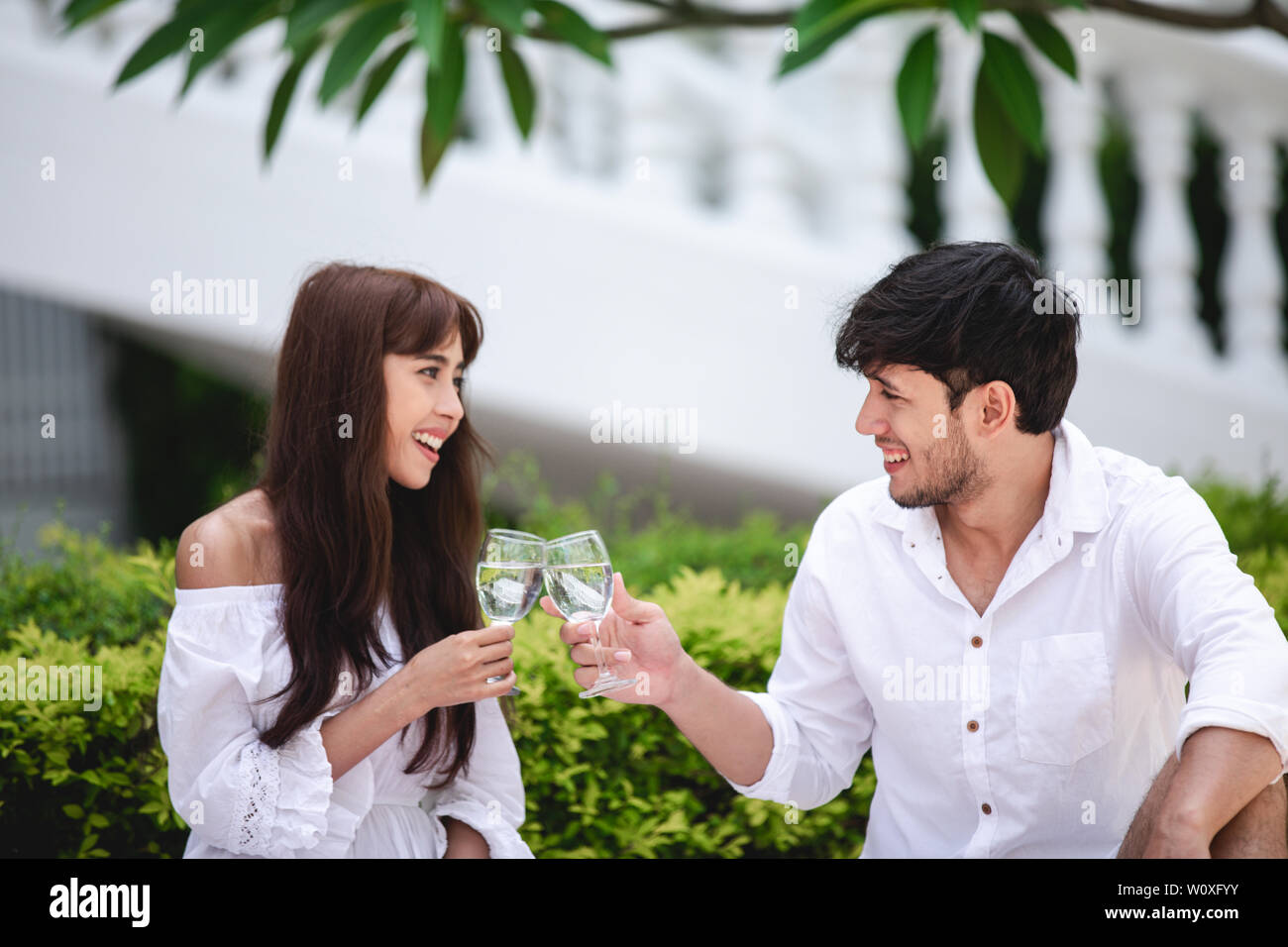 Happy Romantic Couples lover talking and drinking wine while having a ...