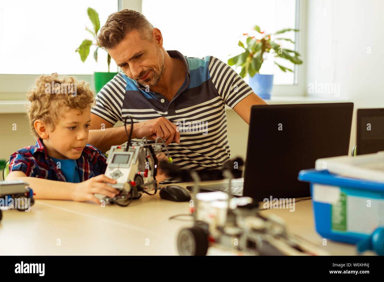 Information technology lesson. Pleasant bearded man sitting together ...