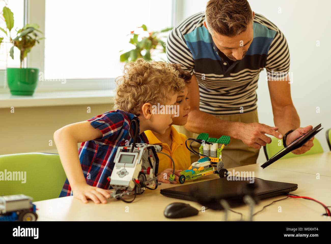 Professional guidance. Nice smart man holding a tablet in his hands ...