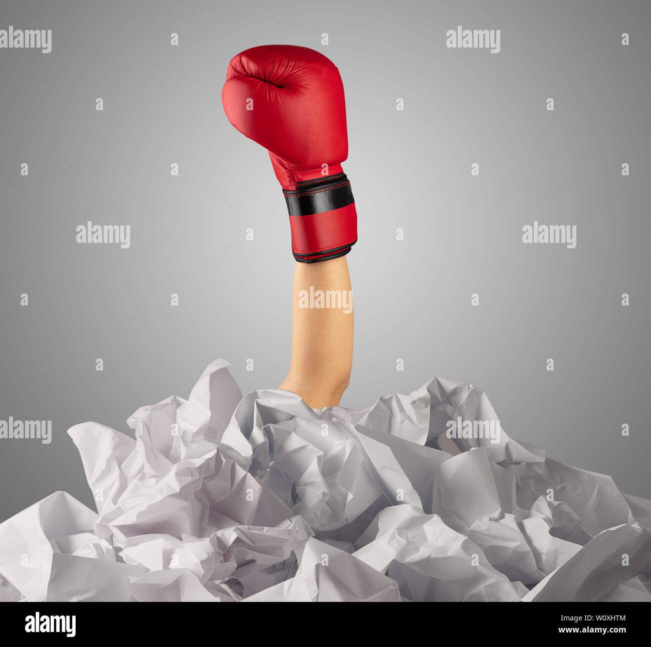 Hand breaking out from pile of paper Stock Photo - Alamy